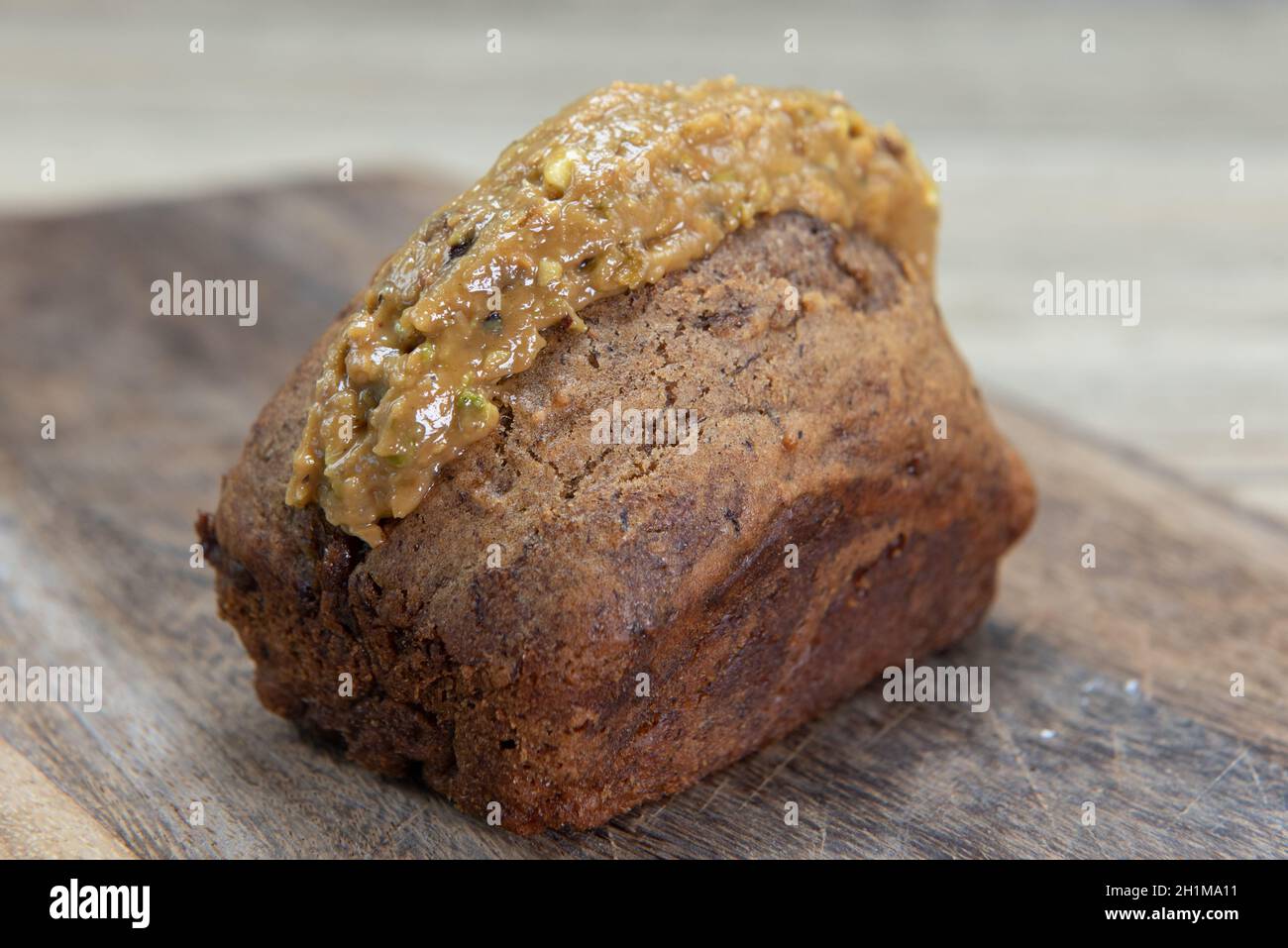 Freshly baked loaf of banana bread slathered with pistachio butter and ...