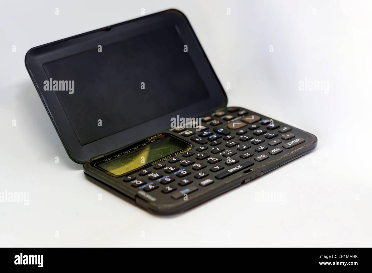 Old electronic organizer with liquid crystal display with the flap open ...