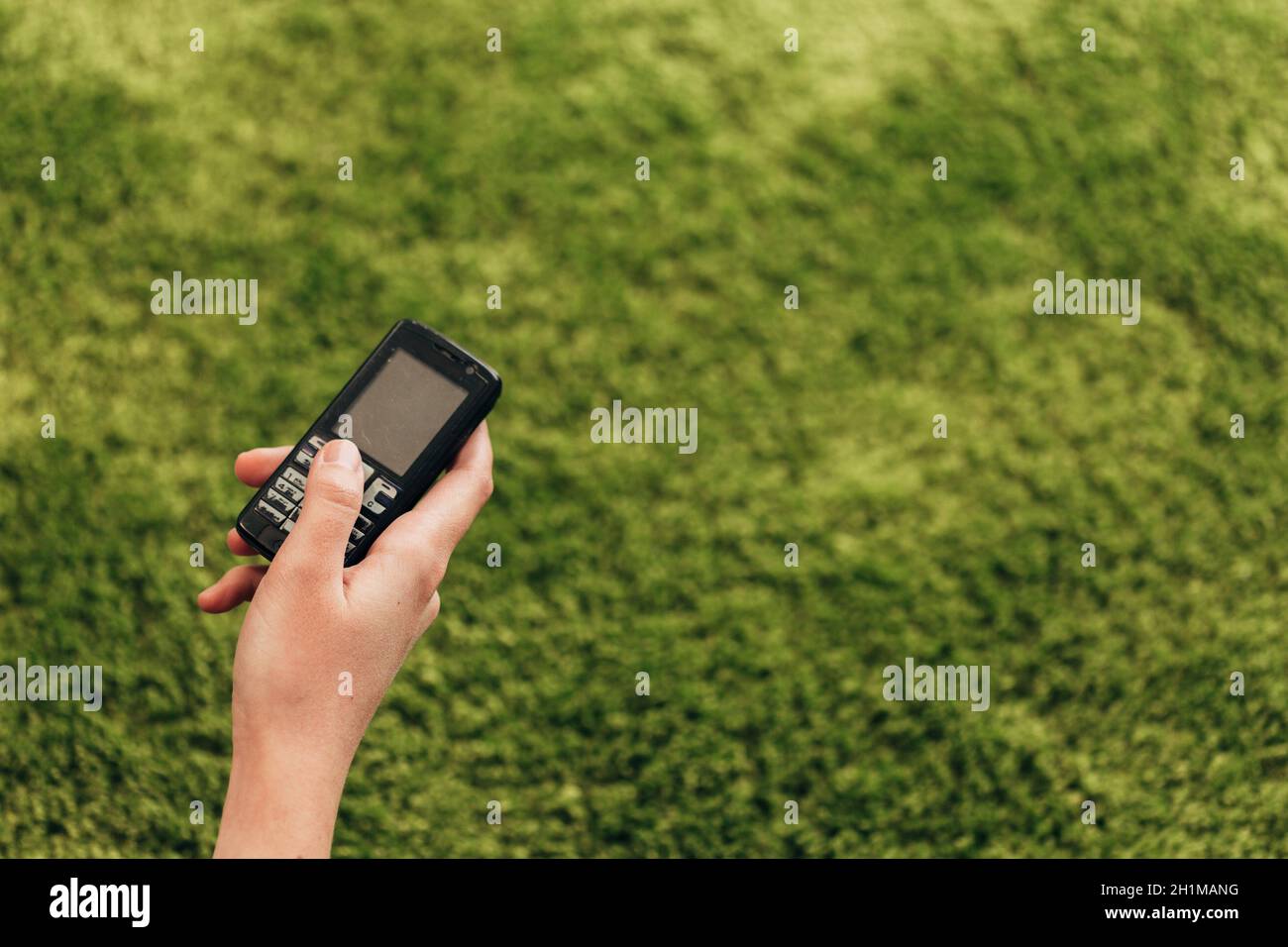Girl Holds An Old Button Phone In Her Hand Stock Photo - Alamy