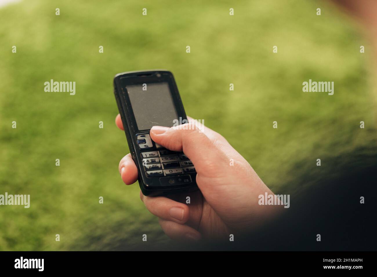 Girl Holds An Old Button Phone In Her Hand Stock Photo - Alamy