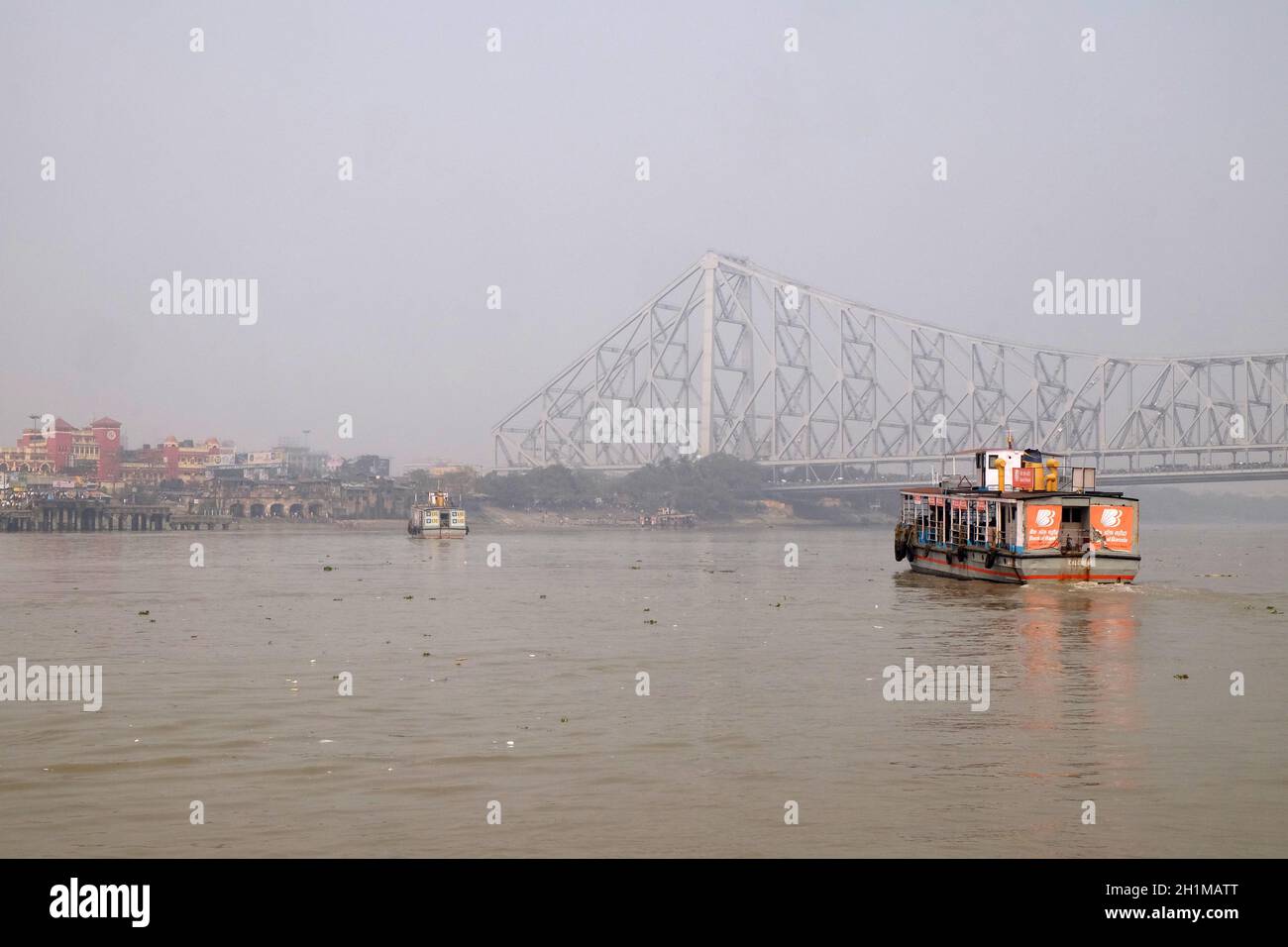 Ferry boat crosses the Hooghly River nearby the Howrah Bridge in ...