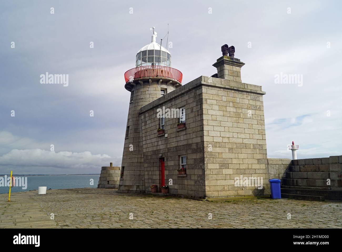 The lighthouse guards the entrance to the port of Howth Stock Photo - Alamy