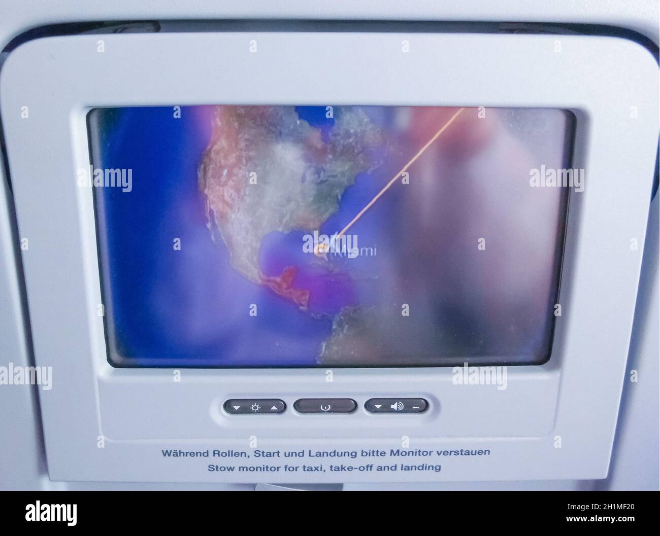 Miami, USA - May 12, 2018: The blue screens display on airplane seat ...