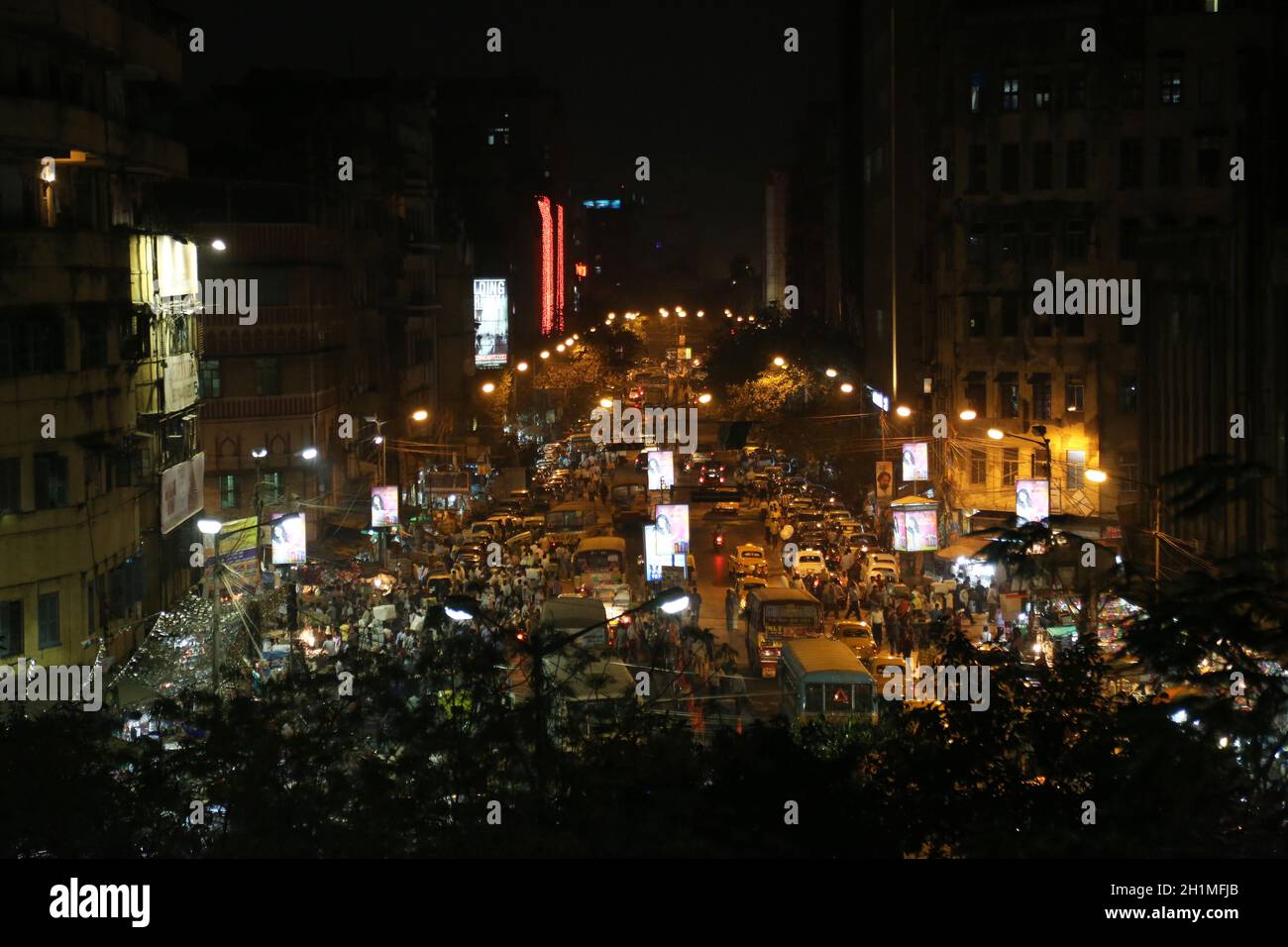 Dark city traffic blurred in motion at late evening on crowded streets ...