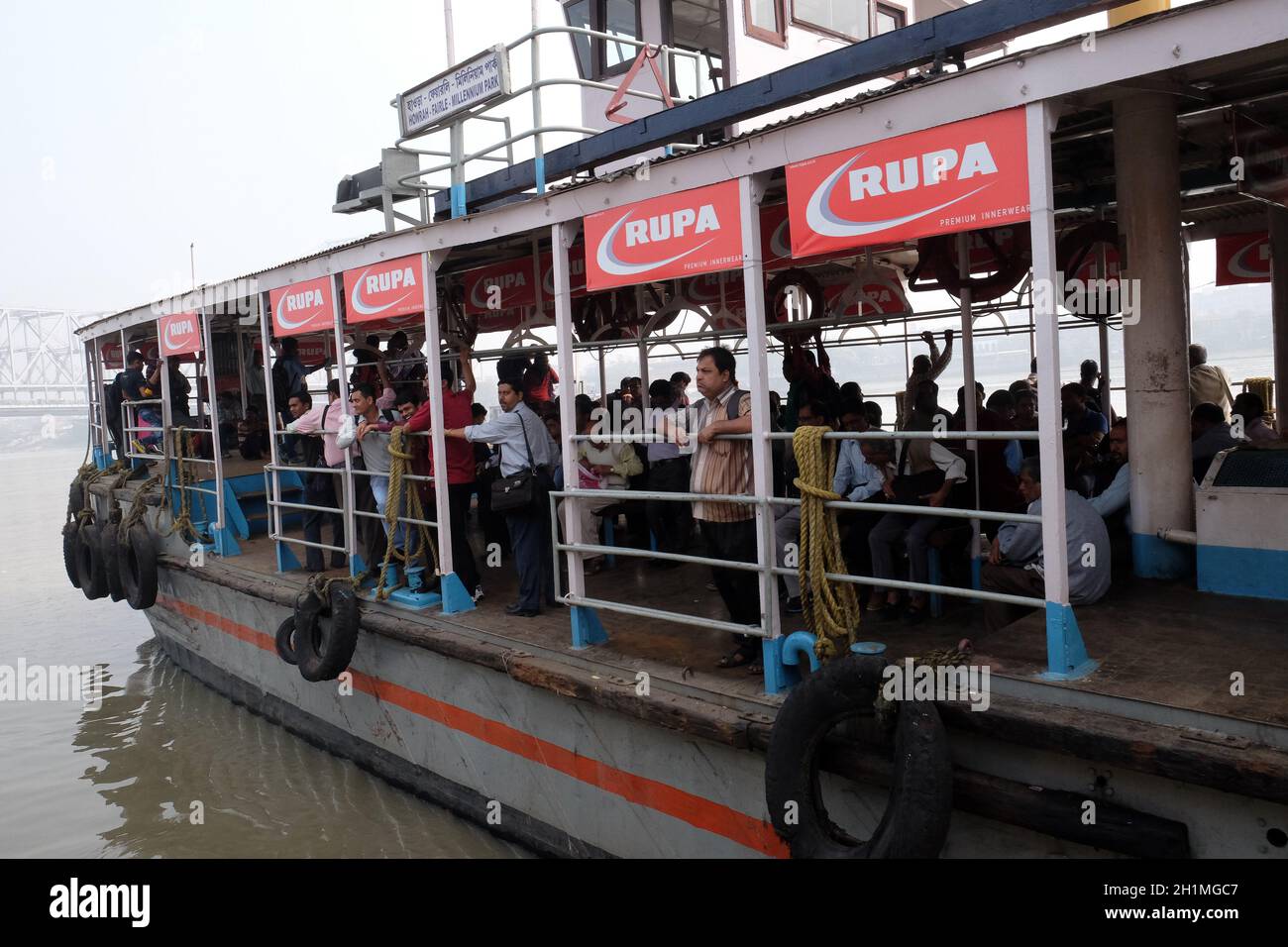 Ferry boat crosses the Hooghly River nearby the Howrah Bridge in ...