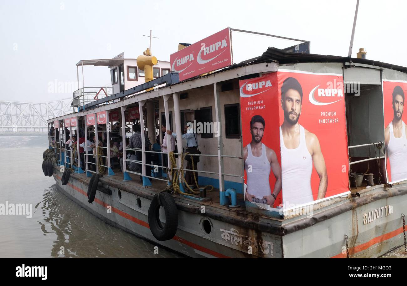 Ferry boat crosses the Hooghly River nearby the Howrah Bridge in ...