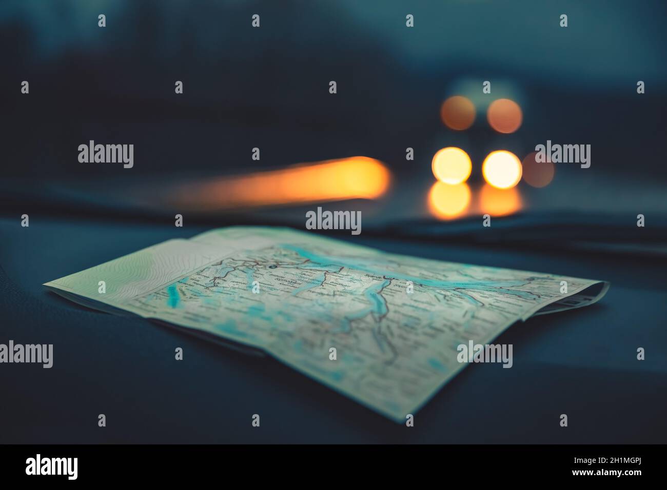 Close Up Photo on a Map used in the Car. Automobile Lights on the ...