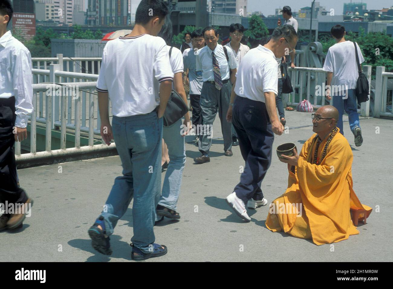 a monks ask for money on a road in the city centre of Taipei in Taiwan ...