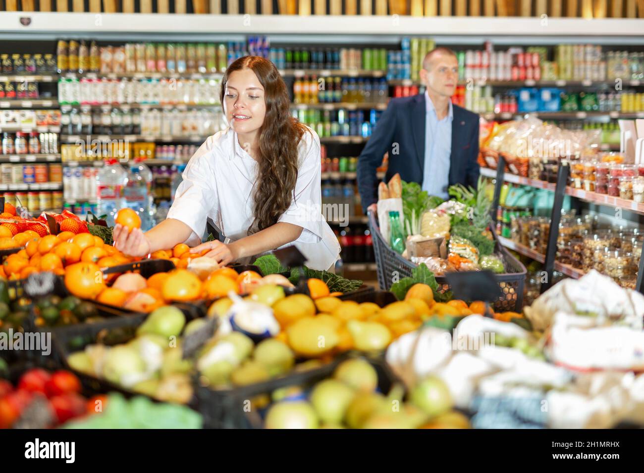 Woman shopping at vegetables department of supermarket Stock Photo - Alamy