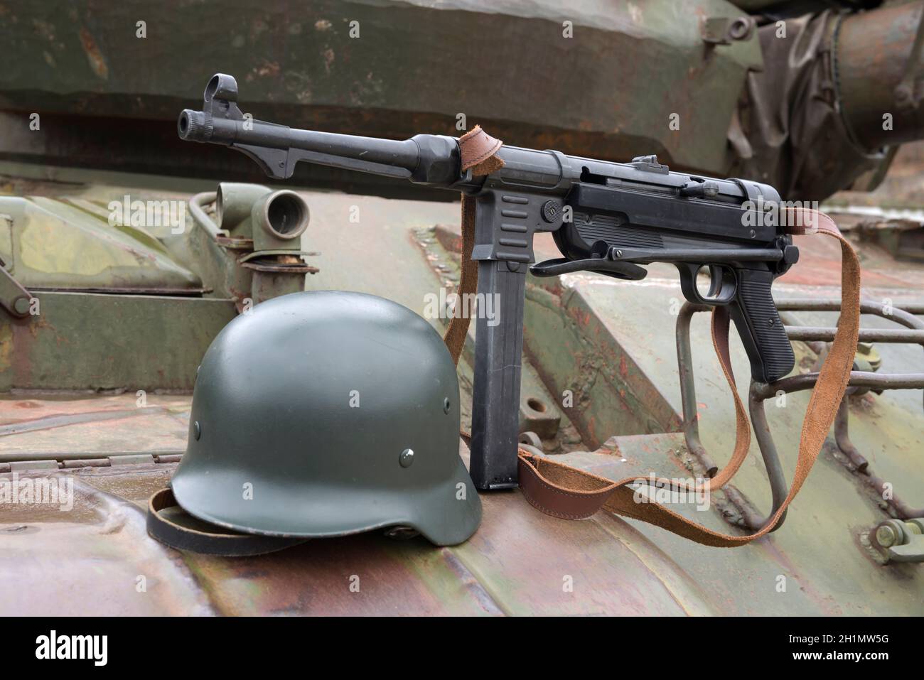 German r submachine gun and helmet on the armor of the tank Stock Photo ...