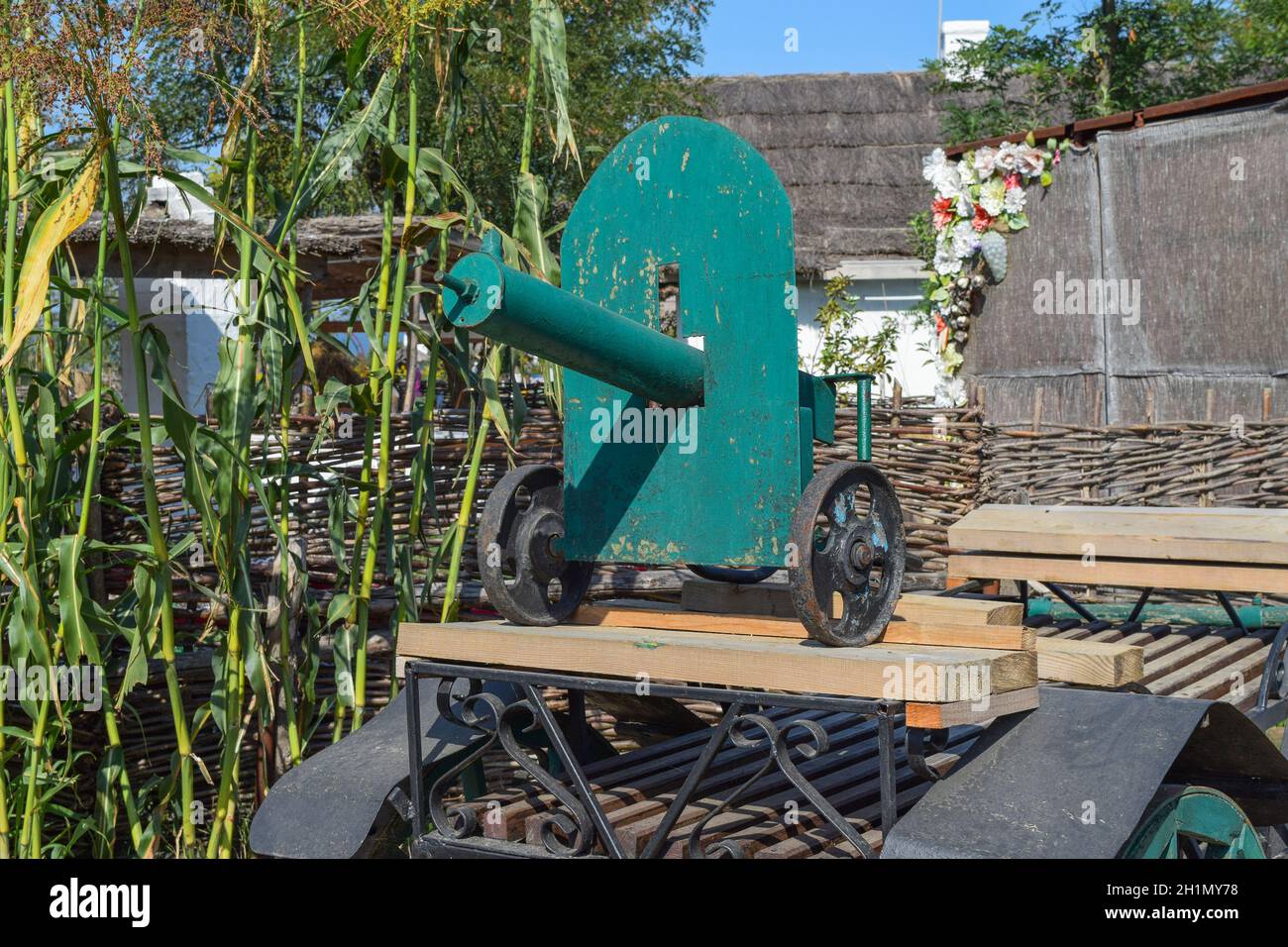 Green fake ancient gun on a cart. Decorative objects Stock Photo - Alamy