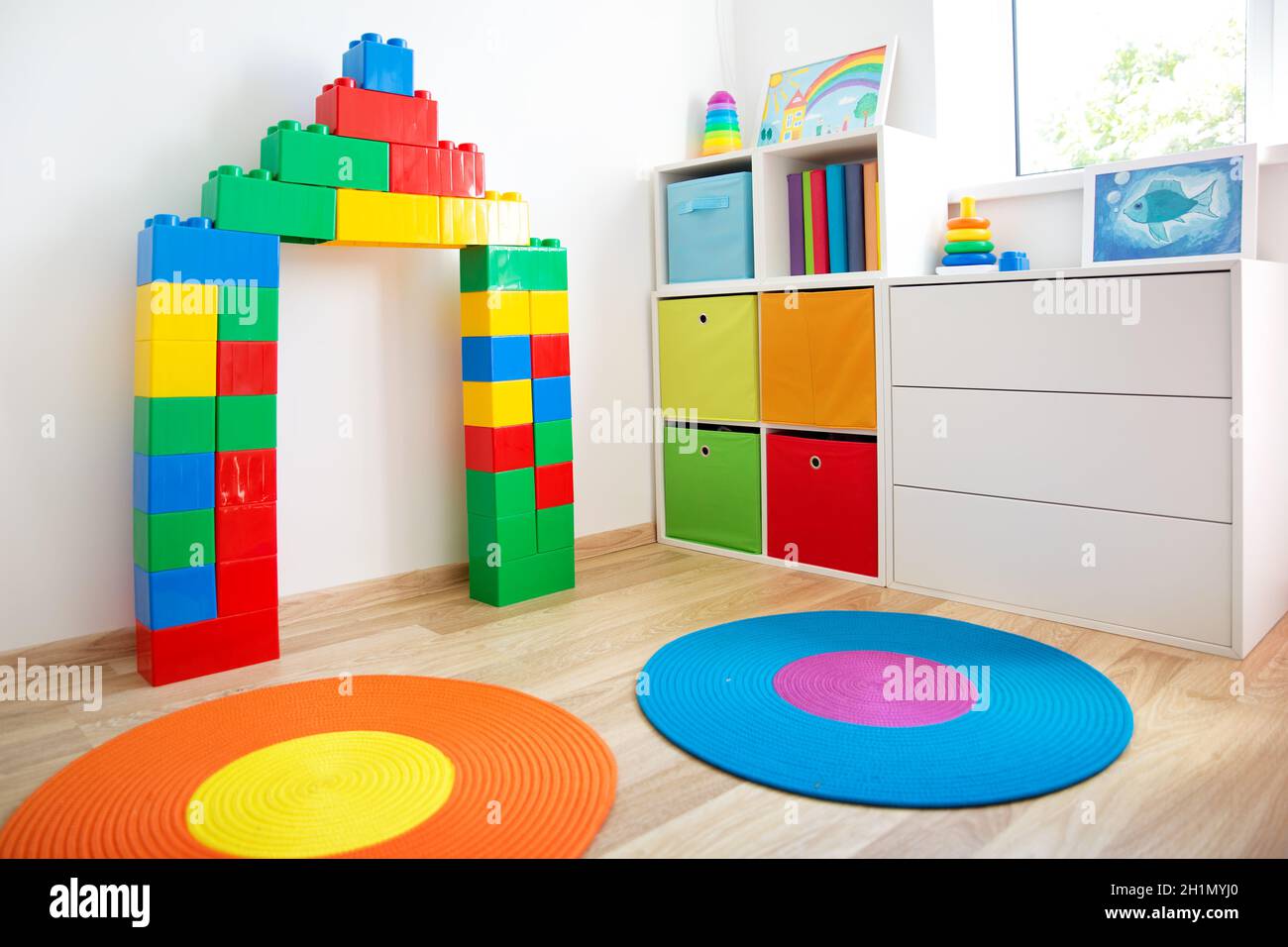 Colourful children rooom with white walls and furniture. Cunstrucktor ...