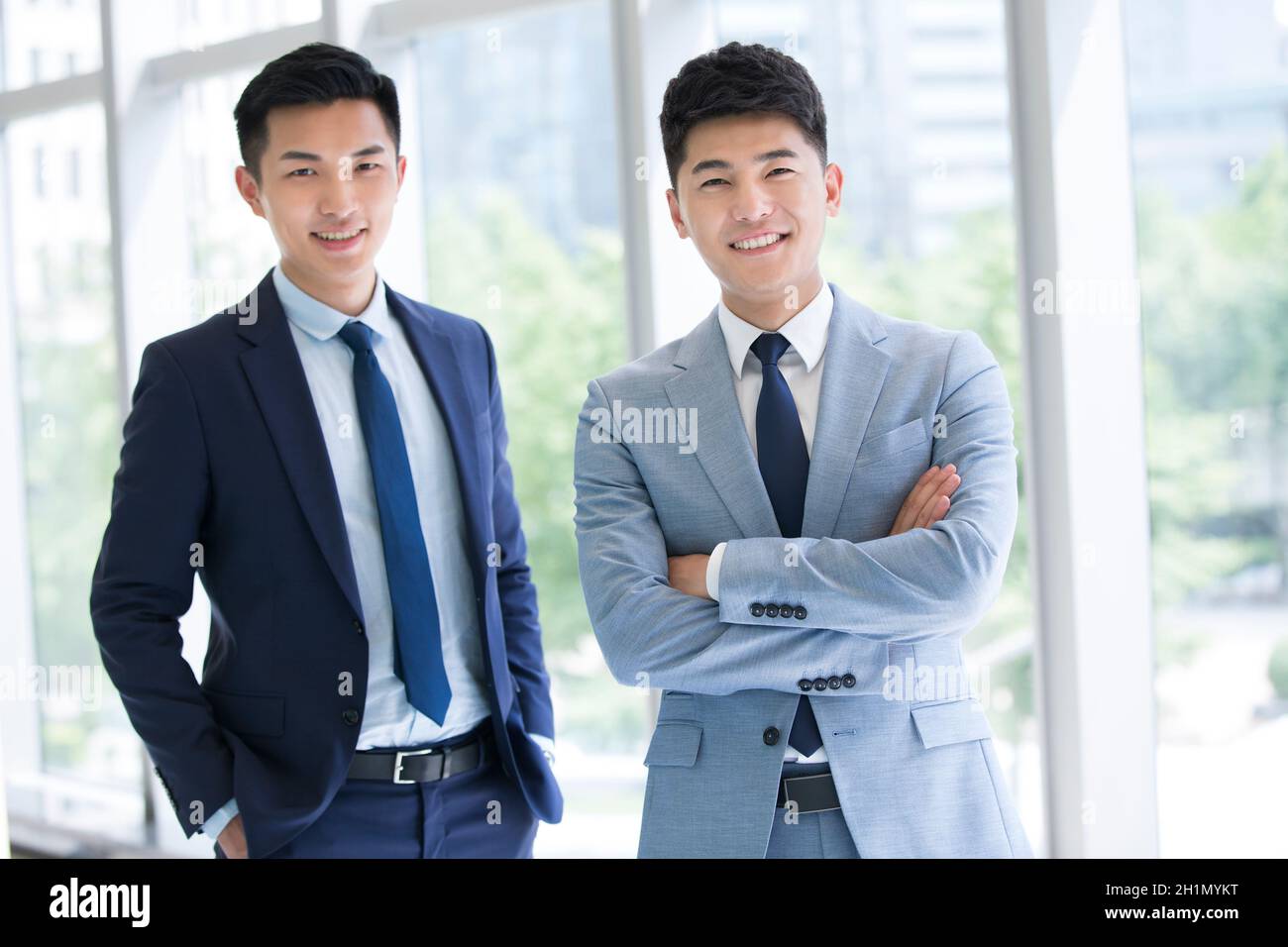 Portrait businessmen standing arms hi-res stock photography and images ...