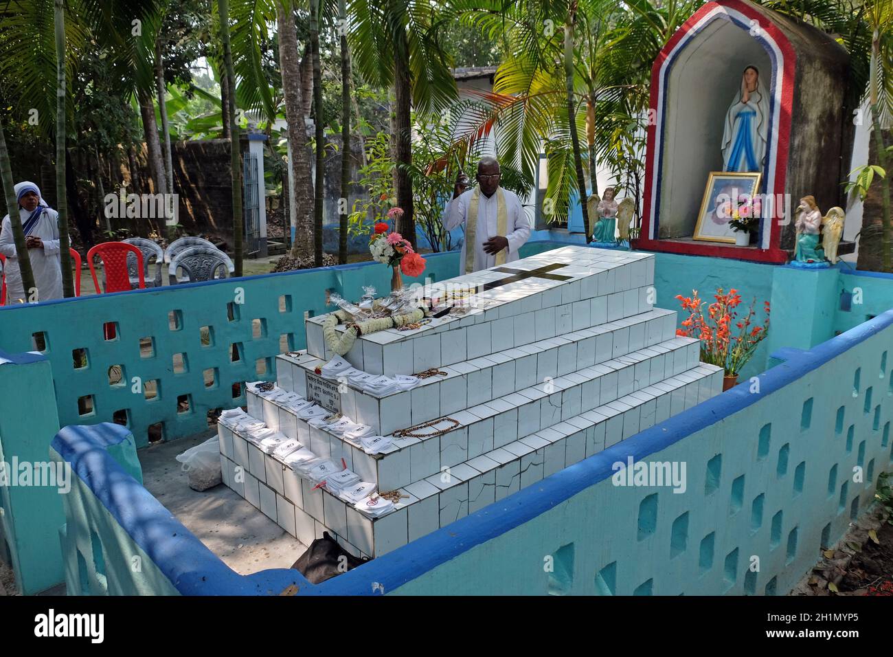 The priest blesses religious objects at the tomb of a Croatian ...