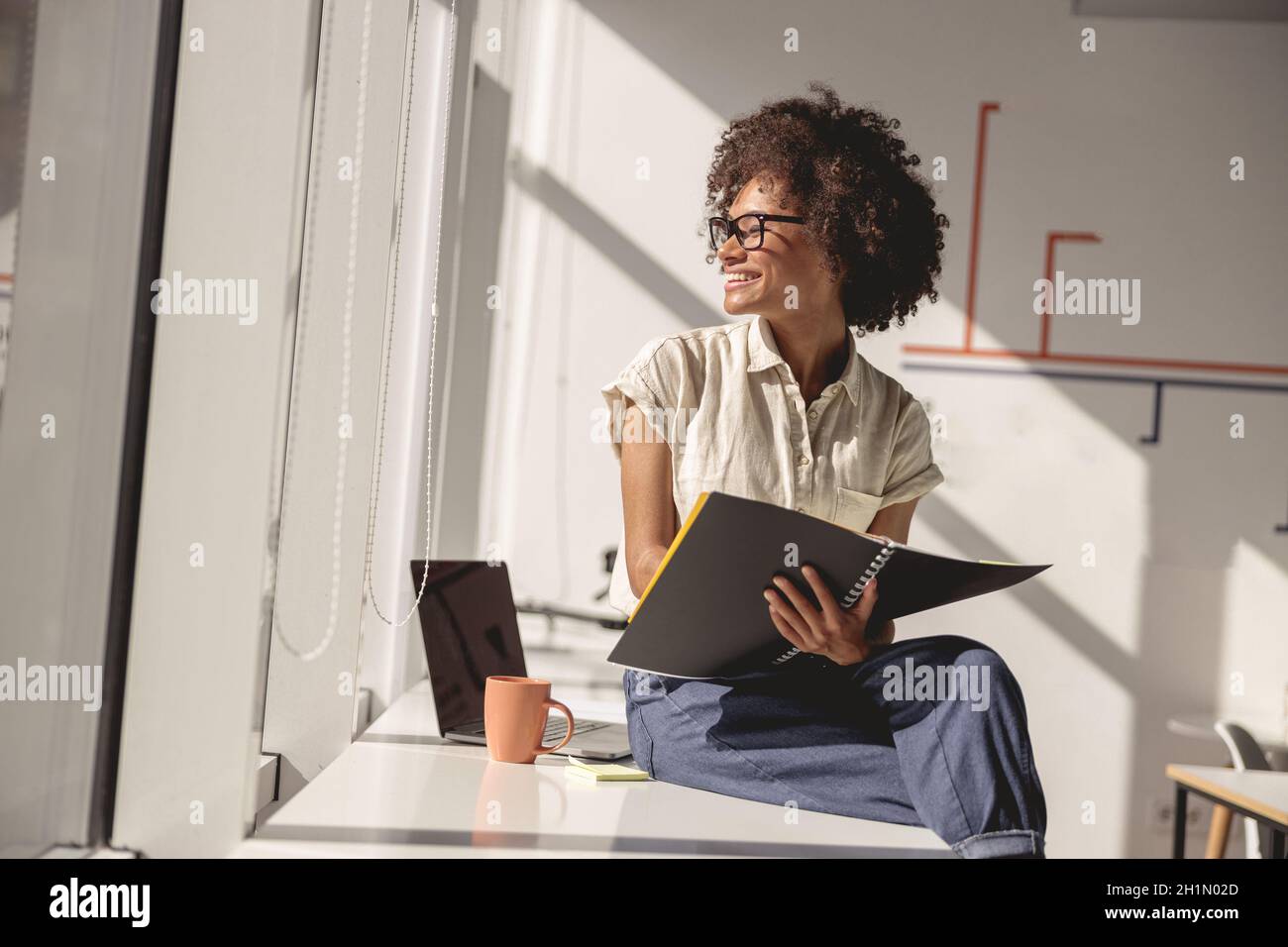 Pretty office lady sitting in hi-res stock photography and images - Alamy