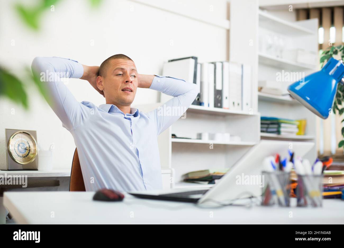 Satisfied businessman leaned back in chair after work done Stock Photo ...