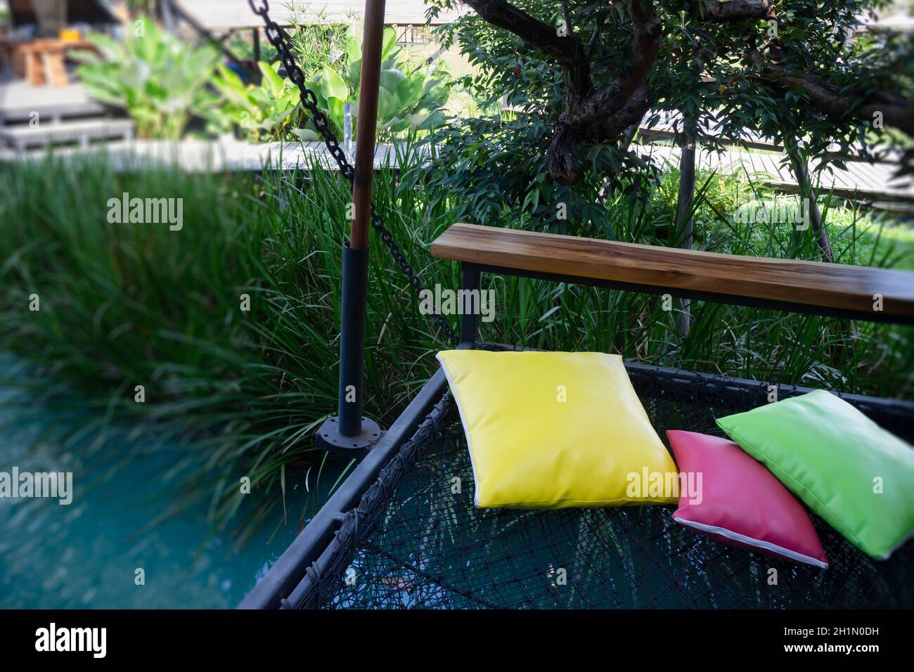Colorful pillows on net seat among nature, stock photo Stock Photo - Alamy
