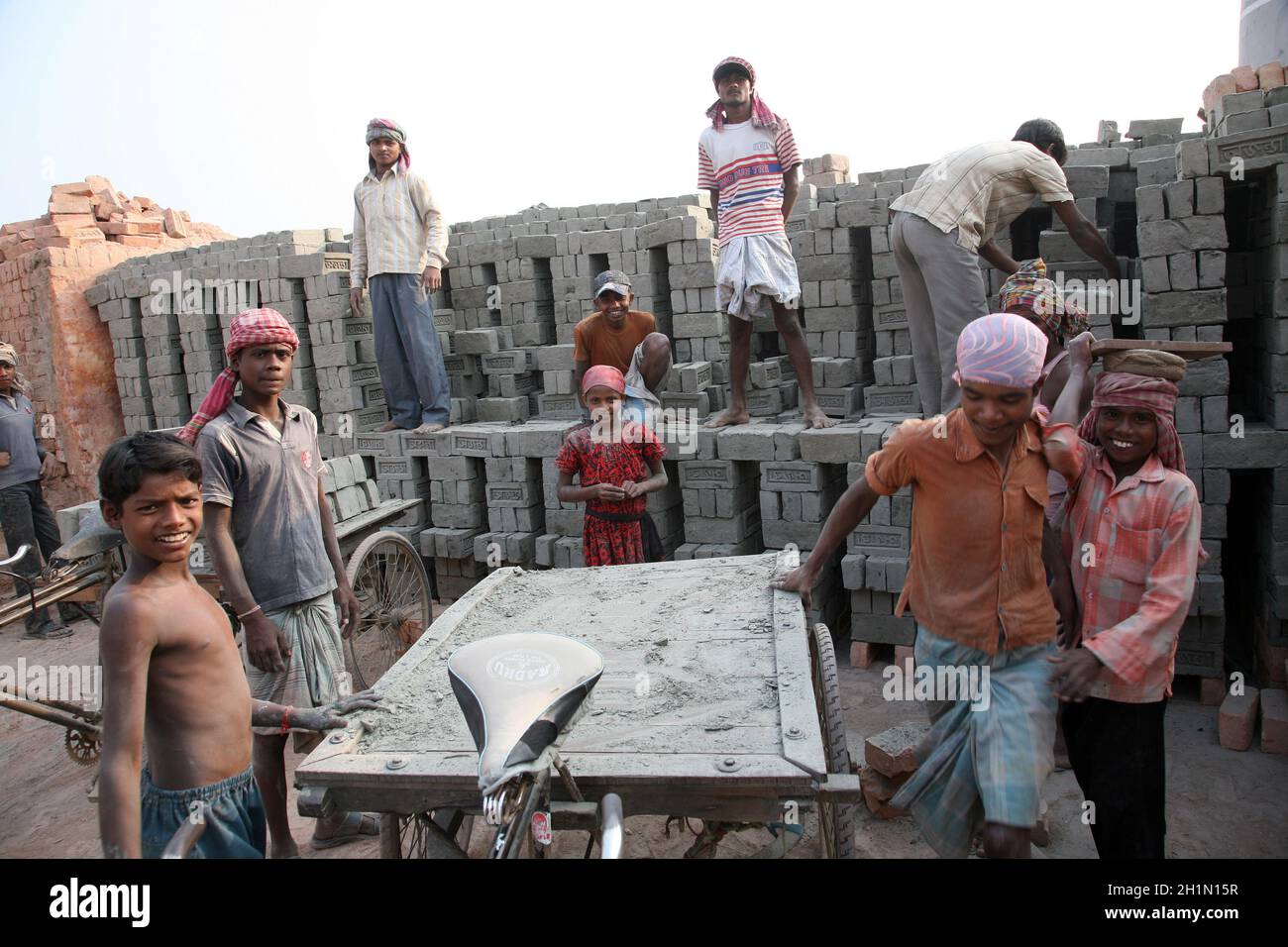 Brick field workers carrying complete finish brick from the kiln, and ...