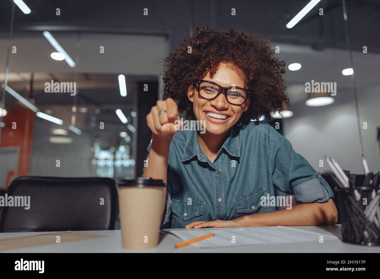 Friendly pretty woman using sign language in the office Stock Photo - Alamy