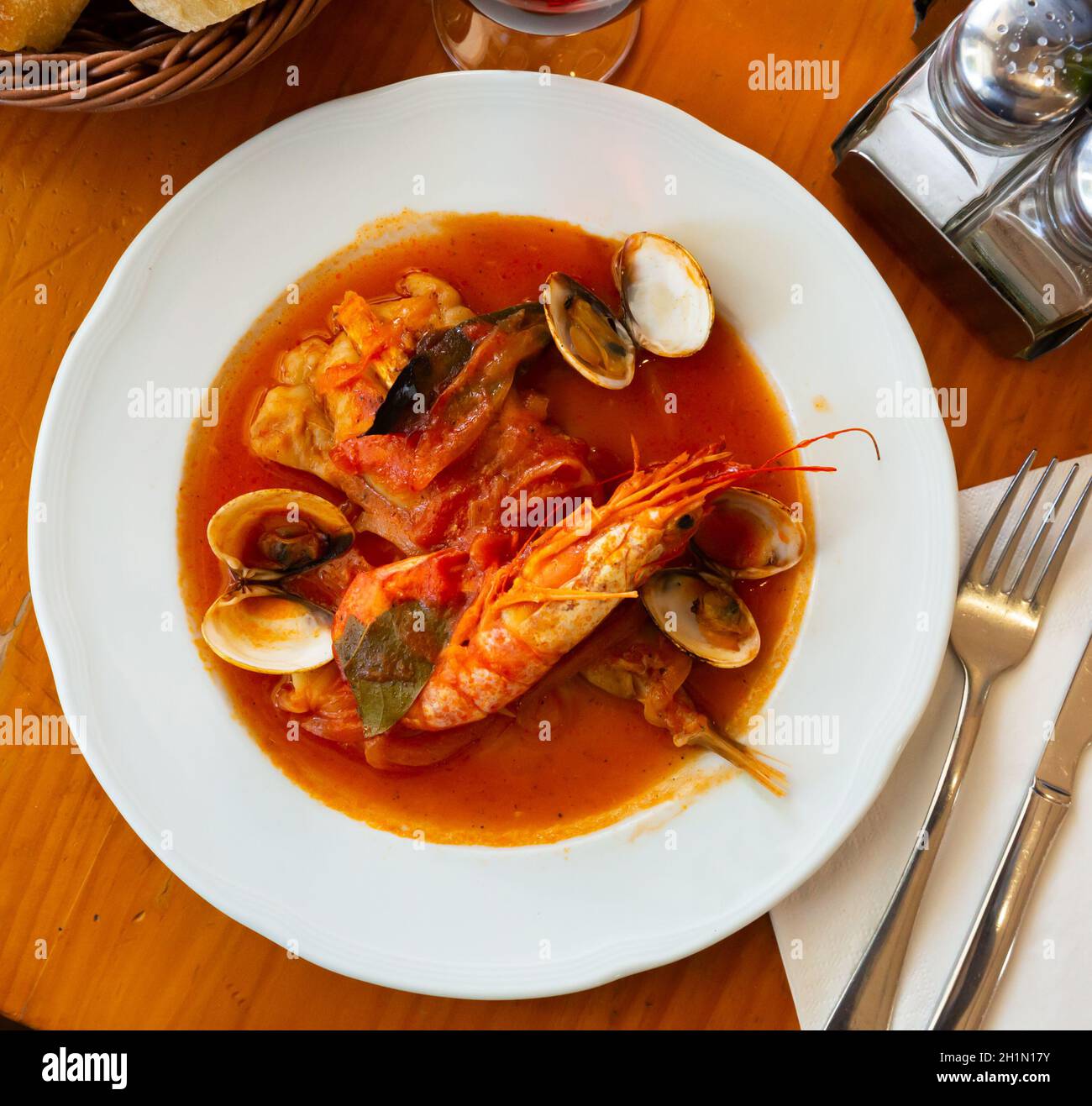 Monkfish tail with clams and shrimps Stock Photo - Alamy