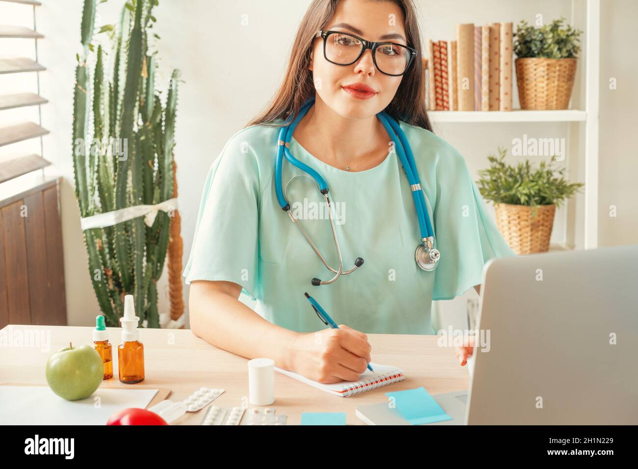 Female medicine doctor filling patient medical form or prescription ...
