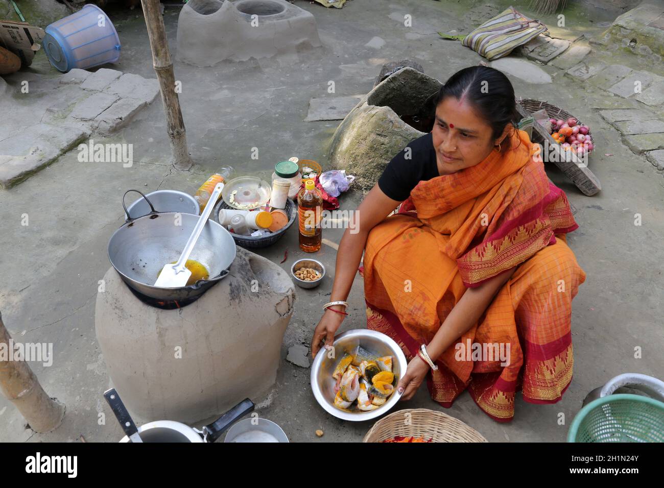 Traditional way of making food on open fire in old kitchen in a village ...