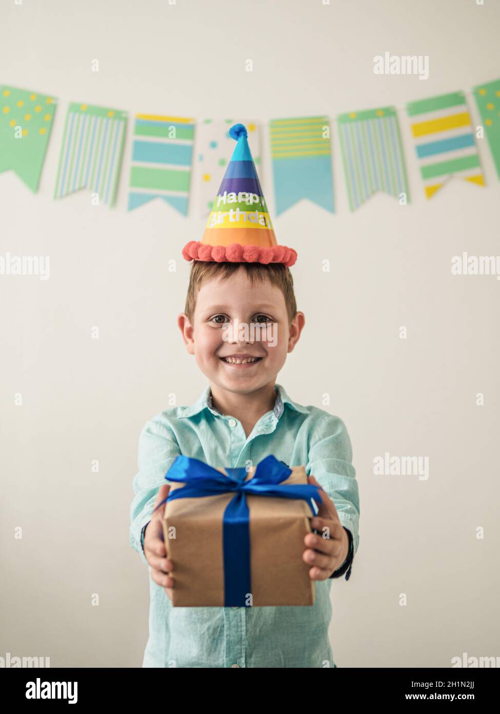 Five year old boy in his birthday hold gift box. Happy little child ...