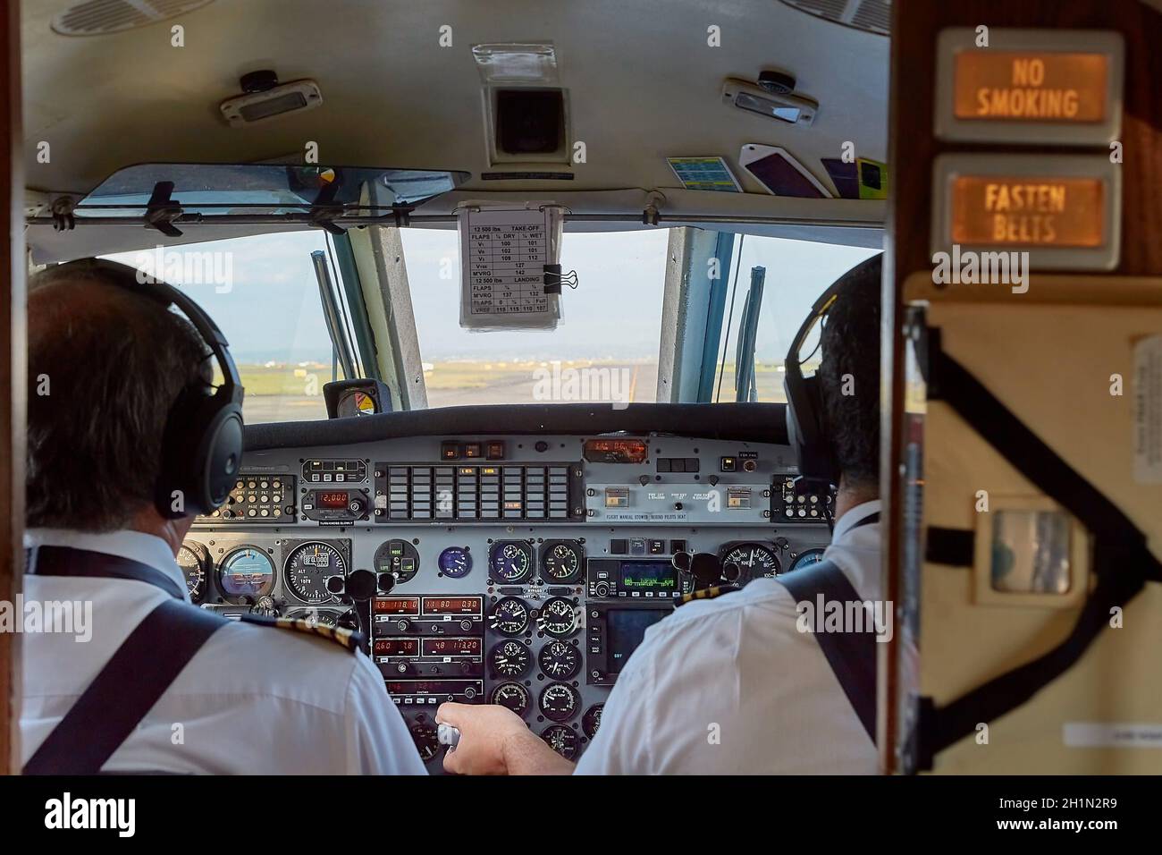 Pilot flying a plane with open cockpit, view of the runway at takeoff ...