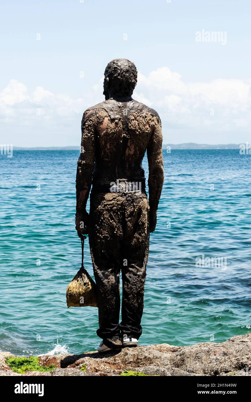 Man covered in oil on the beach at Porto da Barra in Salvador, Bahia ...