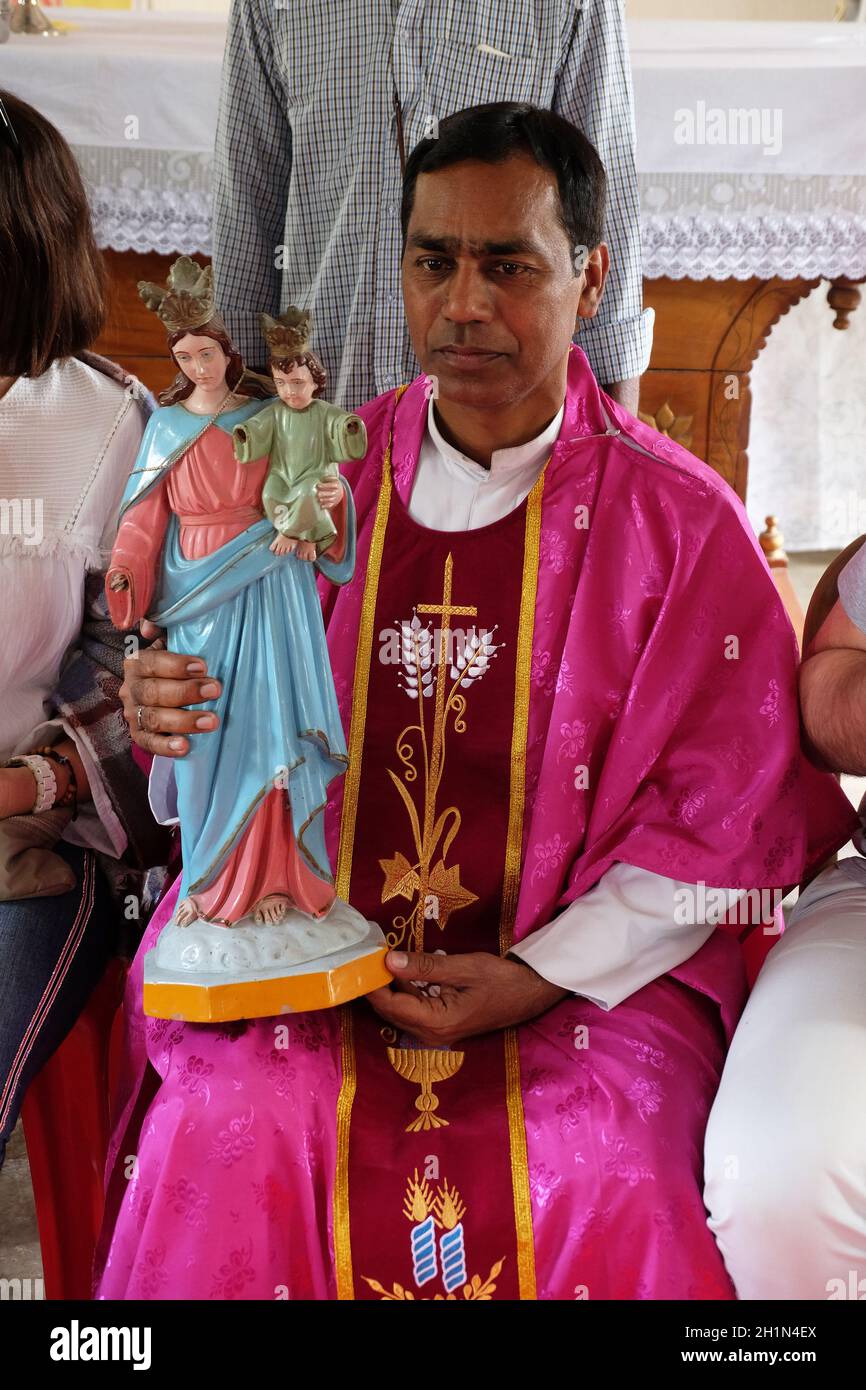 The priest holds a statue of the Virgin Mary with baby Jesus, Catholic ...