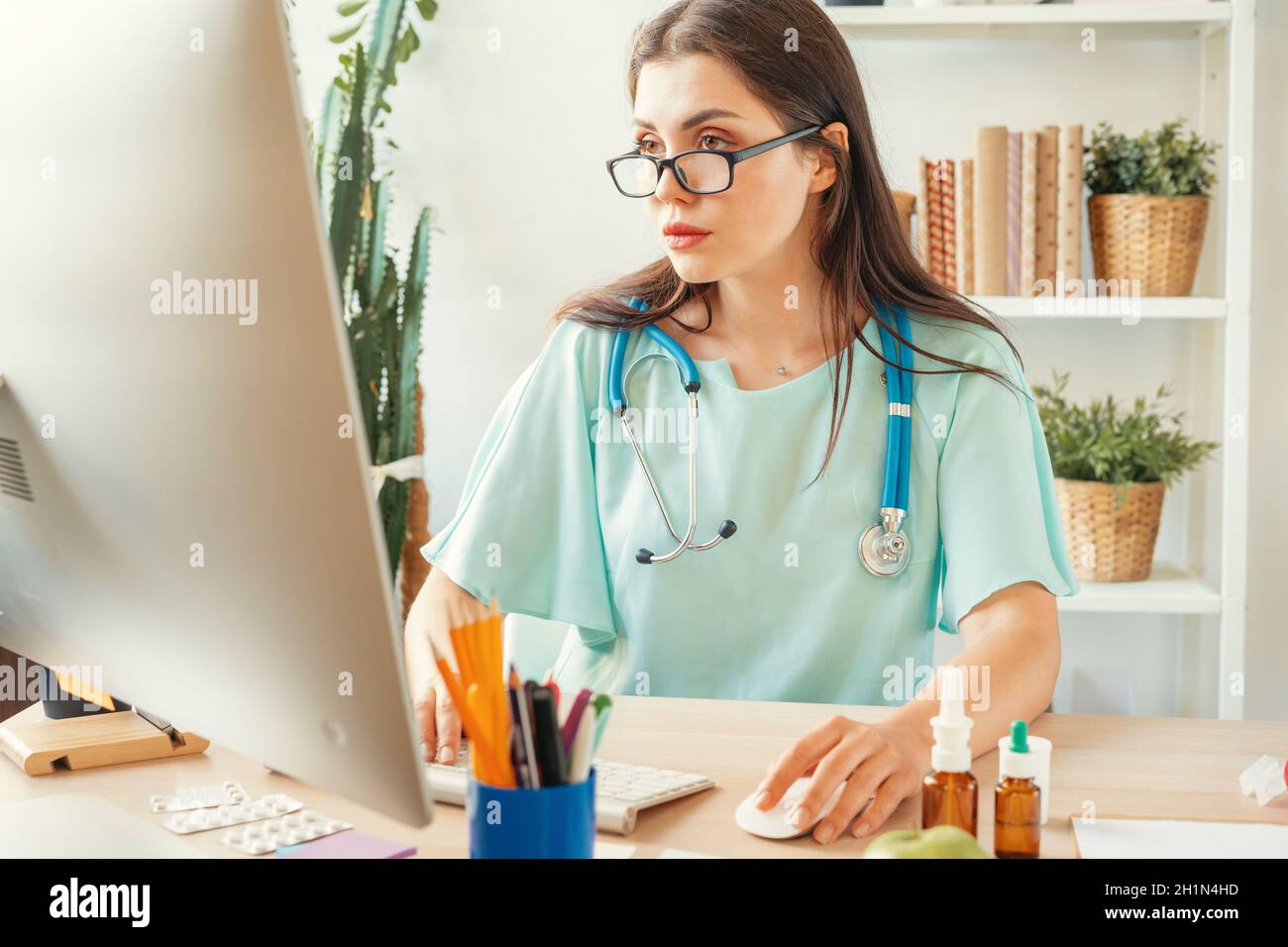 Good looking woman doctor sitting at her table in medical office Stock ...