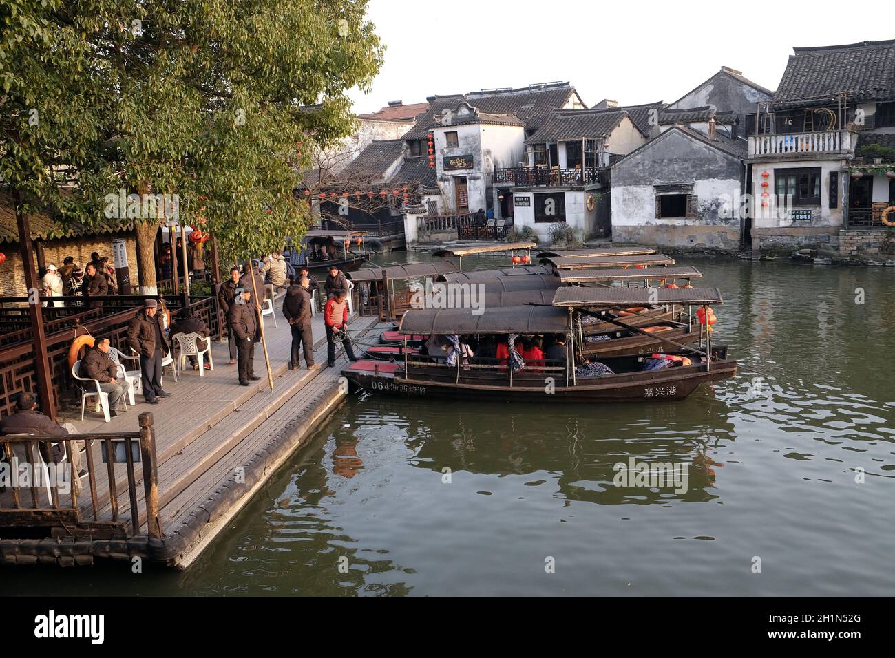 Tourist boats on the water canals of Xitang Town in Zhejiang Province ...