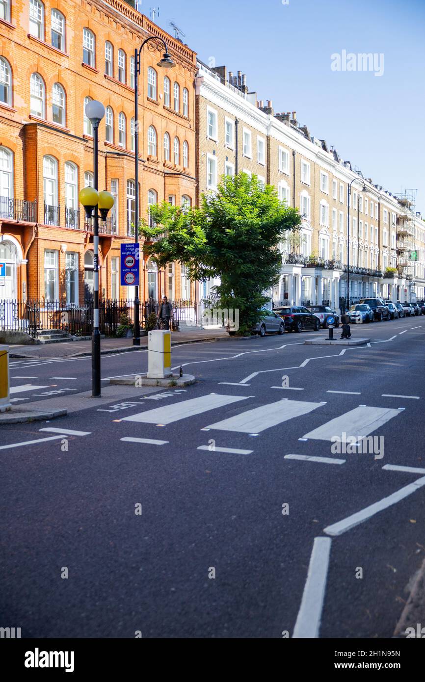 Row of apartment brick buildings in tranquil British street under clear ...