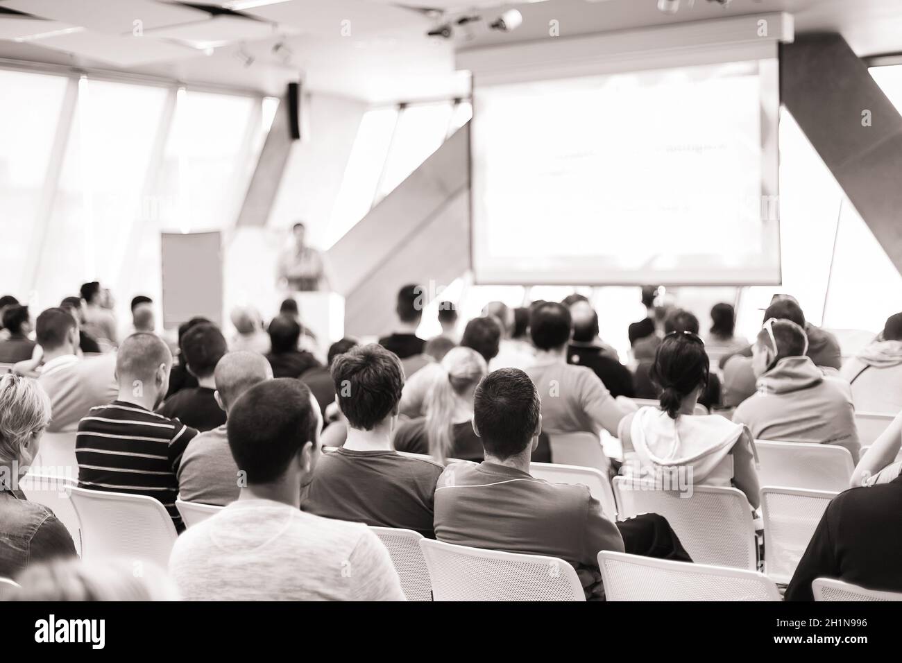 Man giving presentation in lecture hall. Male speeker having talk at ...