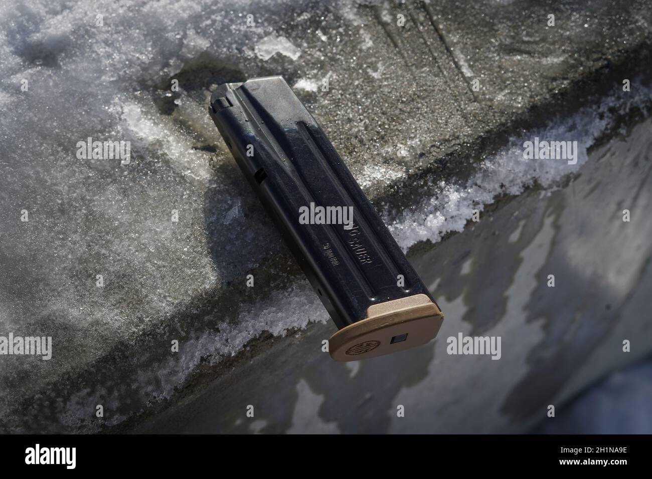 An empty 9mm magazine rest on a concrete barrier as paratroopers ...