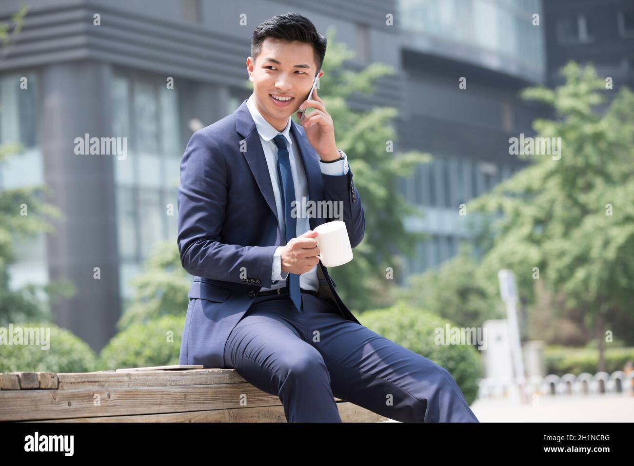 Confident businessman talking on the phone Stock Photo - Alamy