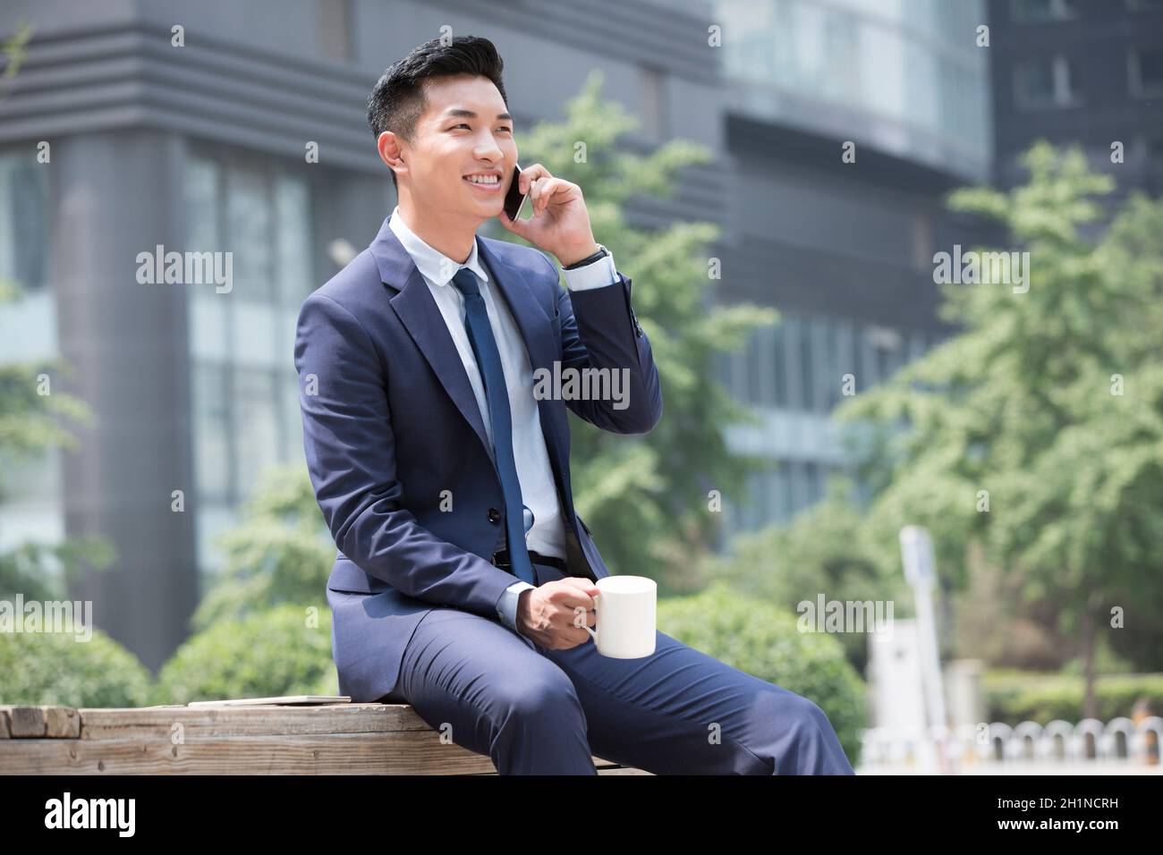 Confident businessman talking on the phone Stock Photo - Alamy