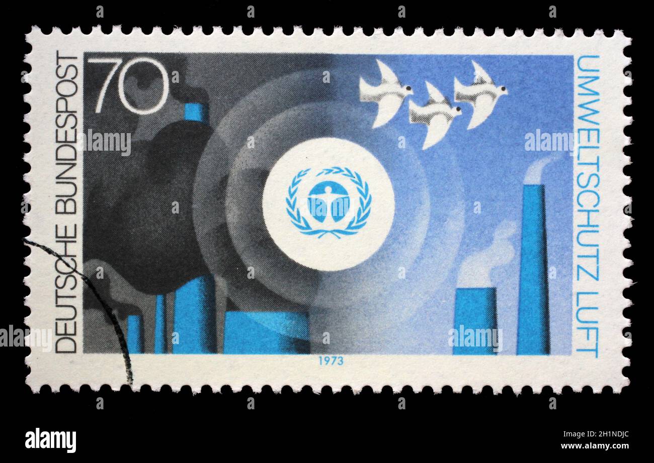 Stamp printed in the Germany shows Environment Emblem and pollution of ...