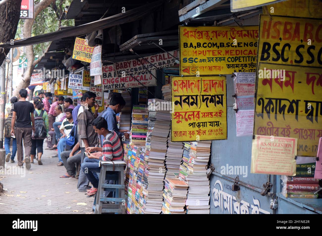 Students check out books at an old street side book stall at College ...