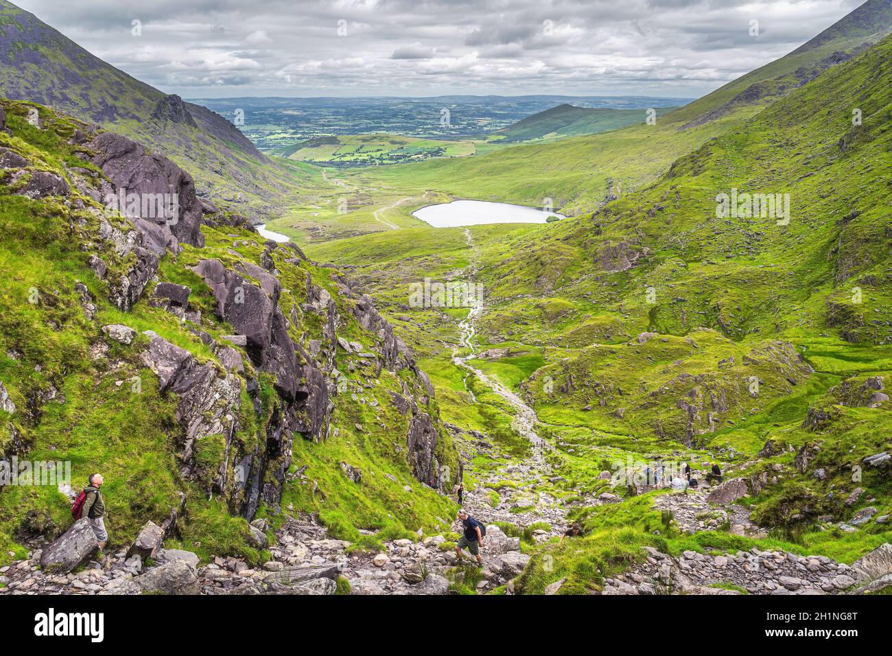 Killarney, Ireland, July 2019 Group of hikers climbing Devils Ladder ...