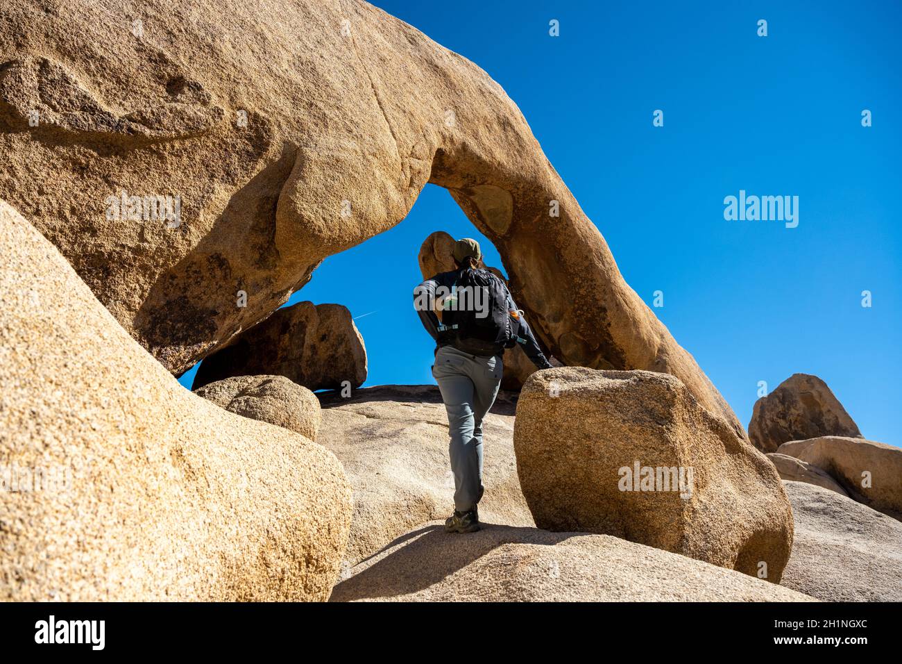 Woman on rock arch hi-res stock photography and images - Alamy