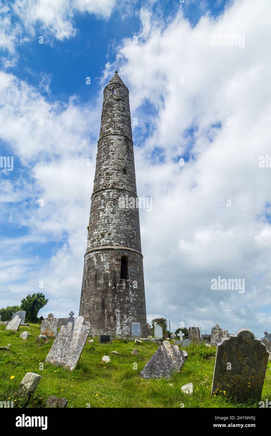 Stone round tower and some ruins of a monastic settlement originally ...
