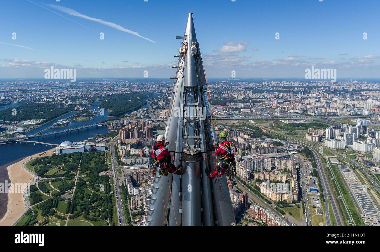 Workers installers at the height work at the top of the skyscraper ...