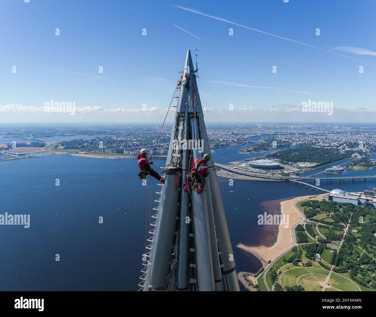 Workers installers at the height work at the top of the skyscraper ...