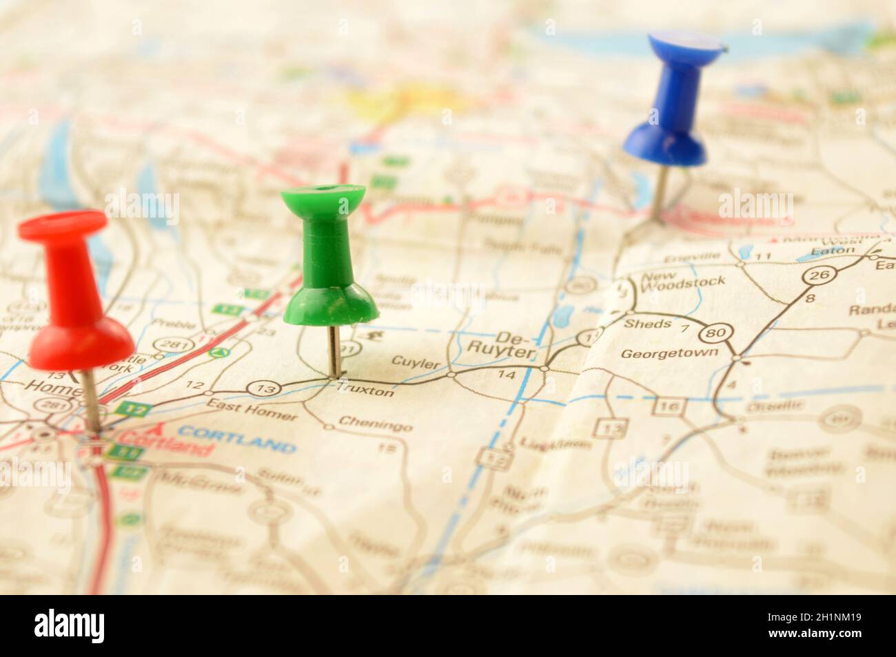 A line of pins pressed into a map detailing points of interest along ...