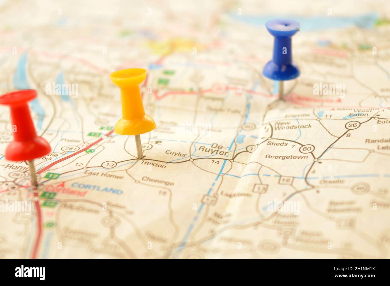 A line of pins pressed into a map detailing points of interest along ...