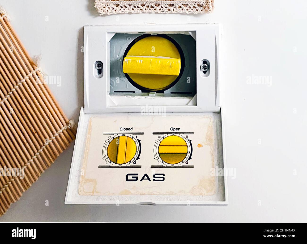 recessed white plastic plate with the yellow valve for closing and ...