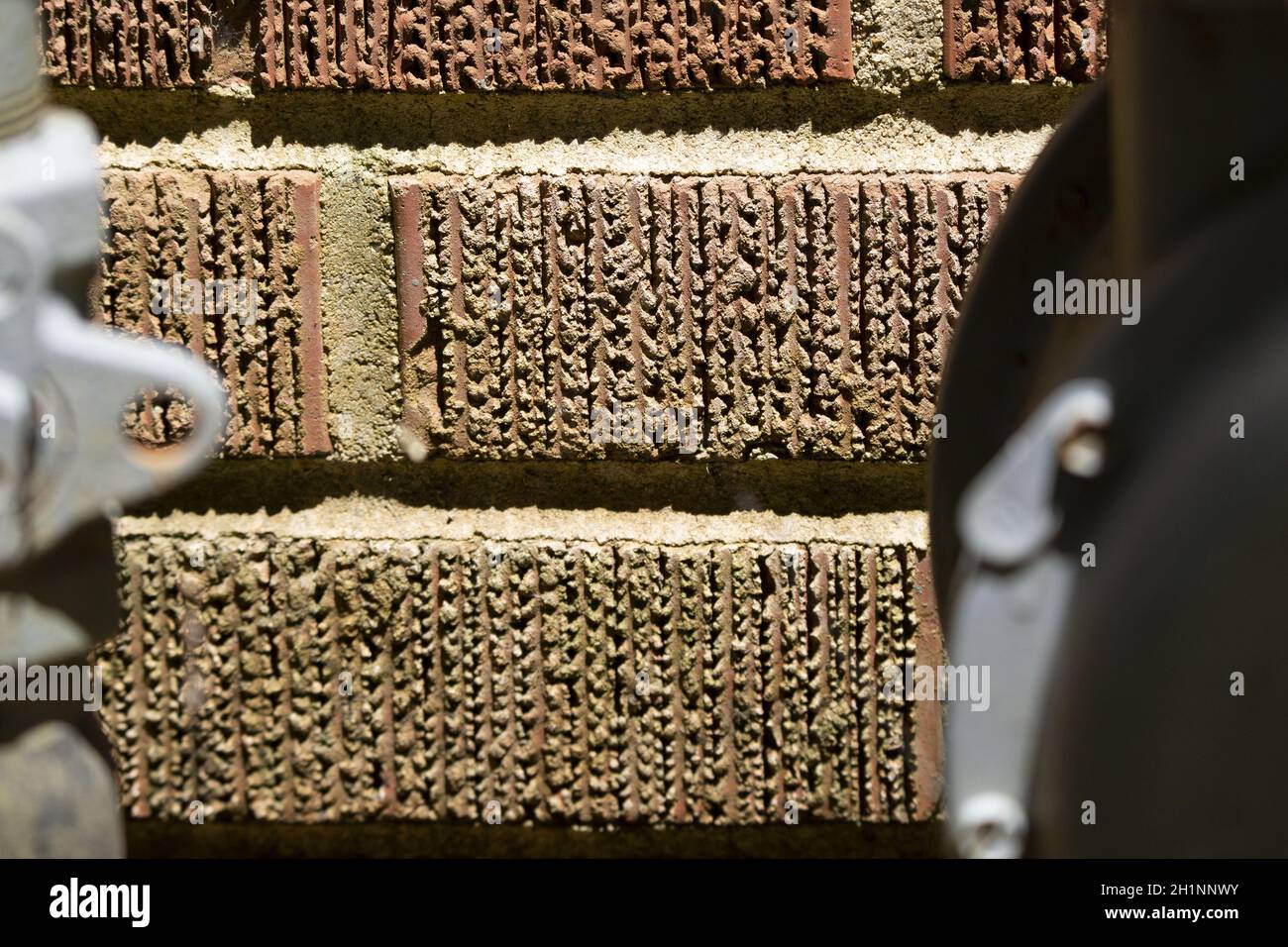 Dingy red brick wall between a water meter and water meter pipe Stock ...