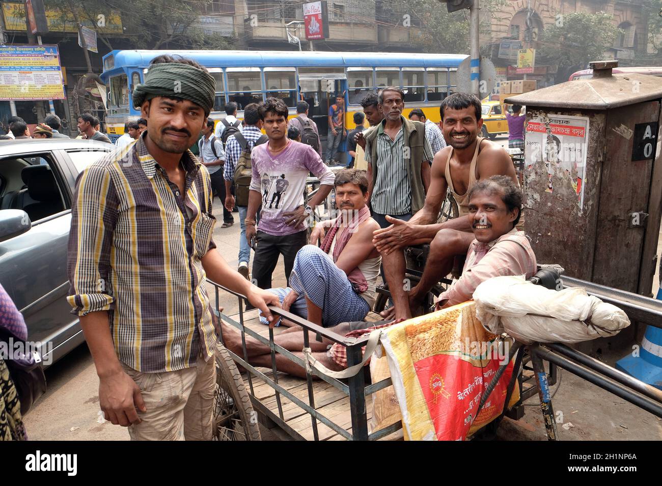 Indian rickshaw drivers posing sitting on tricycle rickshaw in Kolkata ...