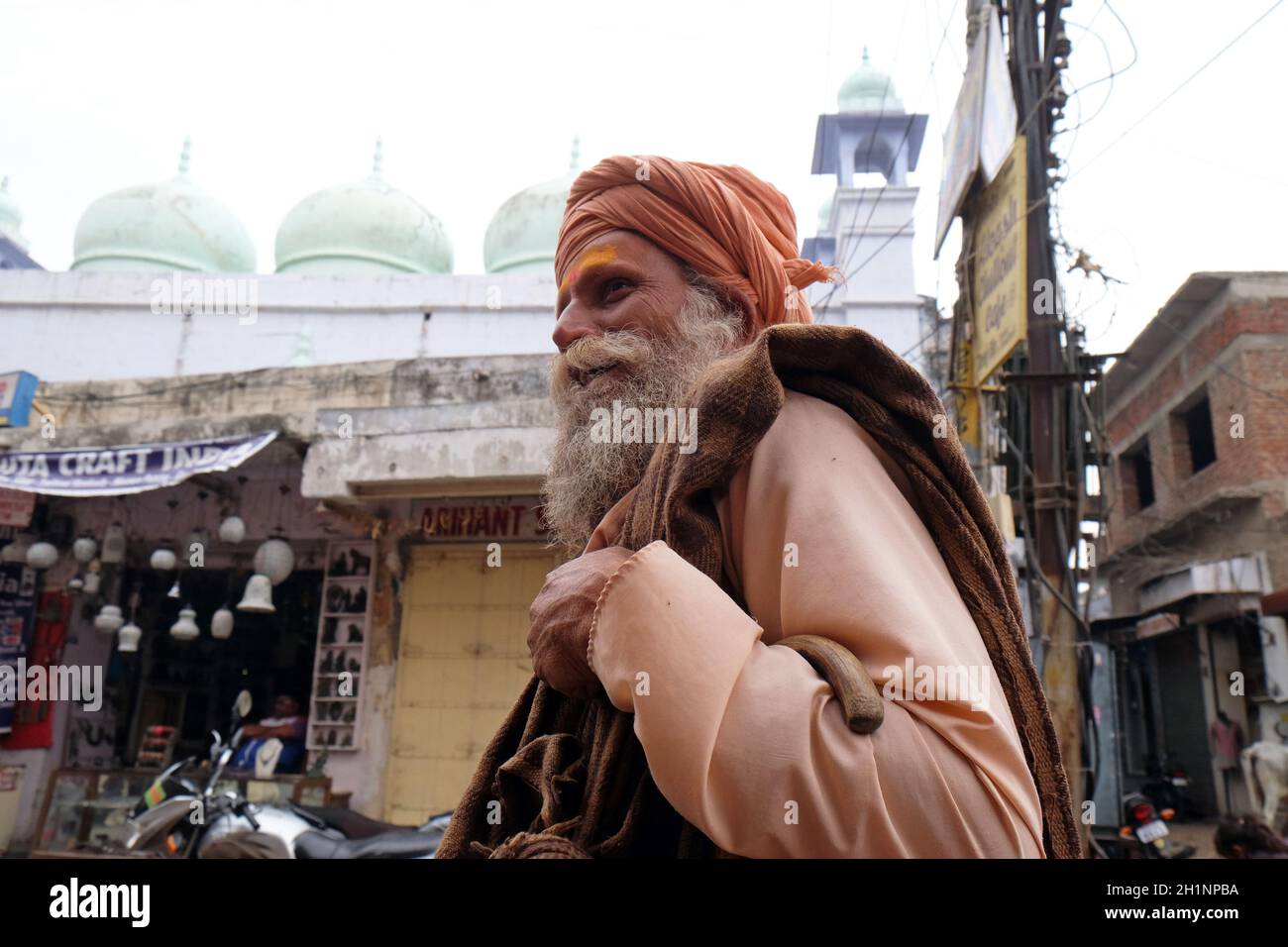 Indian sadhu holy man walking at the bazaar and collect alms in Pushkar ...